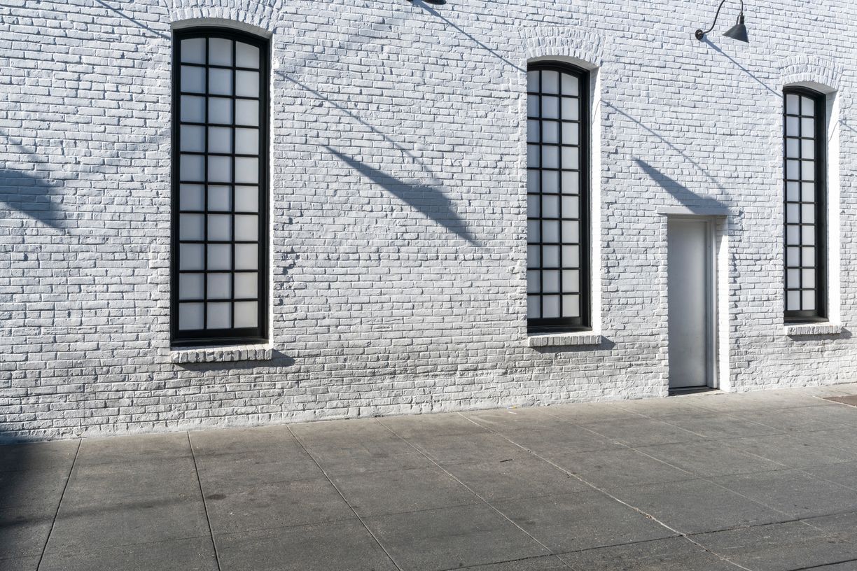 City Life: Windows near a Brick Wall with an Open Door