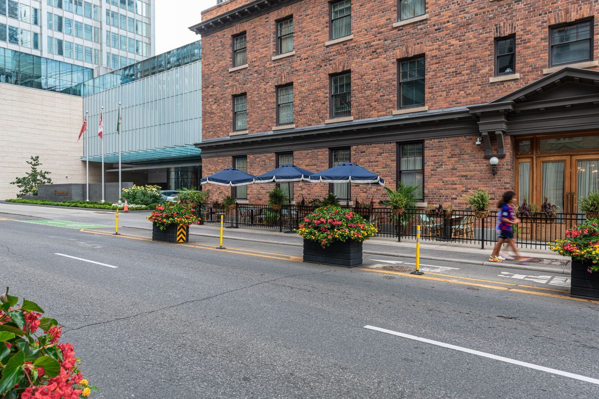 City Life in Toronto: Urban Design with Potted Planters and Brick Wall