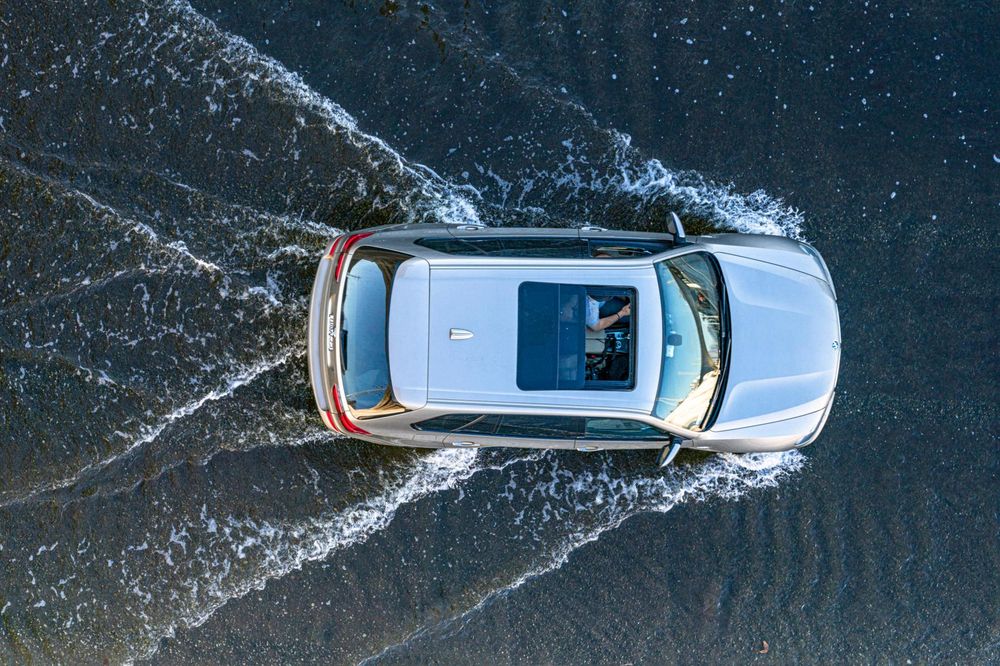 Aerial View of White Vehicle Driving Through Water in Los Angeles ...