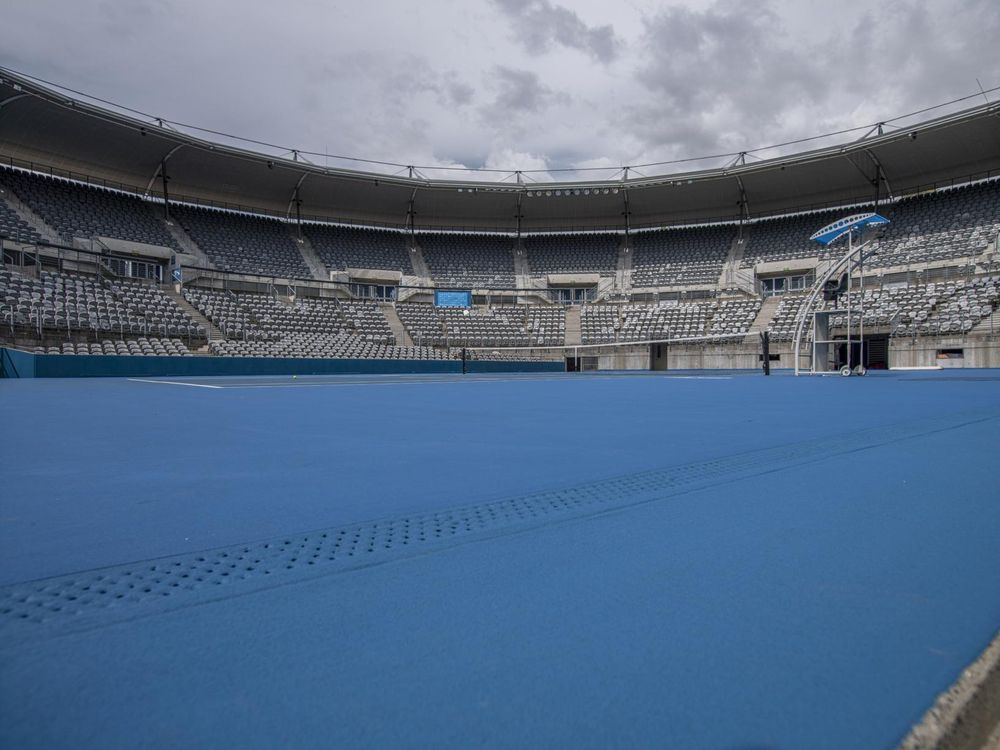 Empty Tennis Court in a Stadium with Overhead View