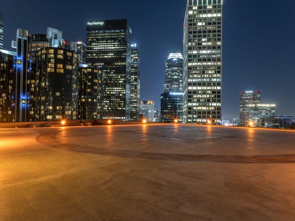 Night view of Los Angeles cityscape with a futuristic architecture ...