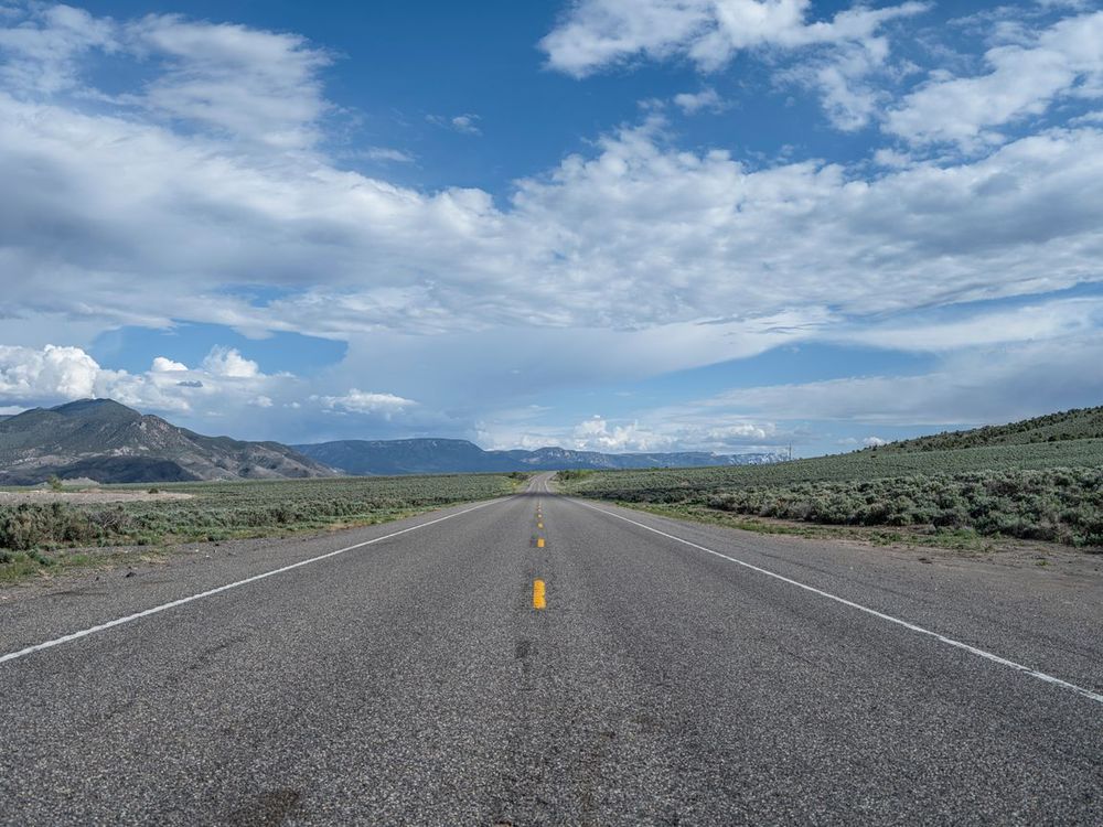 Straight Road in Utah: A Path Through the Clouds and Nature