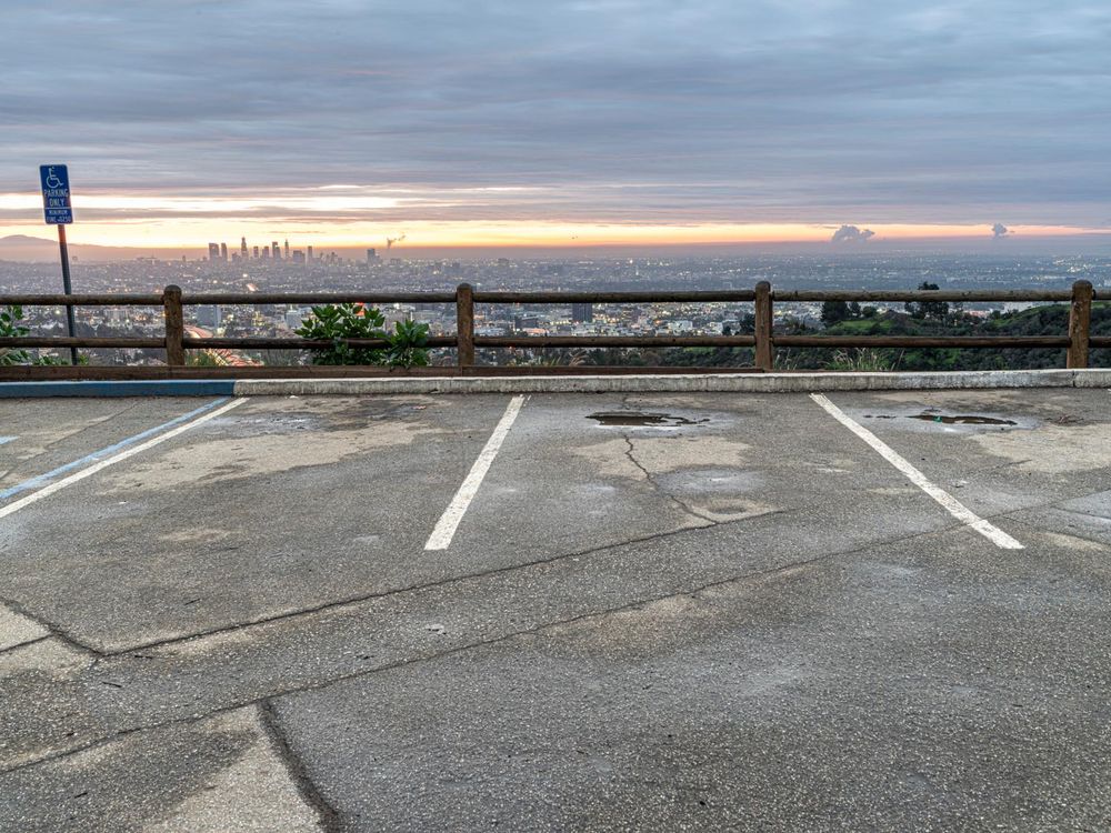 Urban Scene at Dawn: Empty Parking Lot with City Skyline