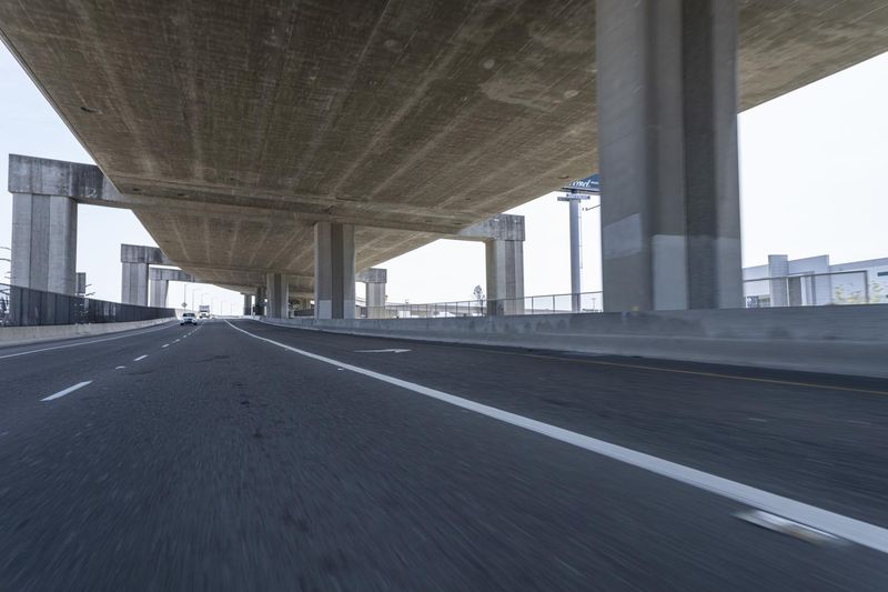 Car driving under a freeway bridge in a city area HDRi Maps and Backplates