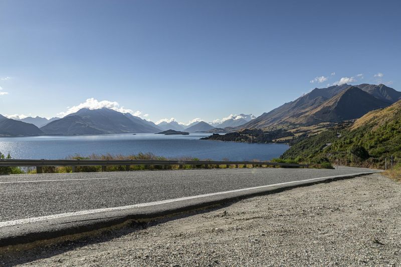 Scenic Coastal Road by the Water with Mountains in the Background HDRi ...