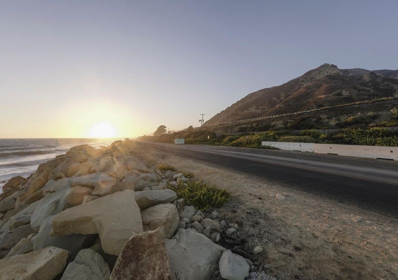 Dawn on a Coastal Road: Asphalt and Mountain Views HDRi Maps and Backplates