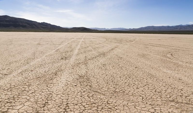 Empty barren area with mountains in Death Valley National Park, USA ...