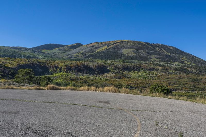 Empty Parking Lot in Front of Steep Mountain Area on Clear Sunny Day ...