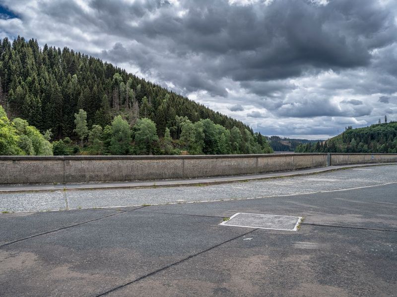 German Rural Landscape with Dam Under Grey Sky