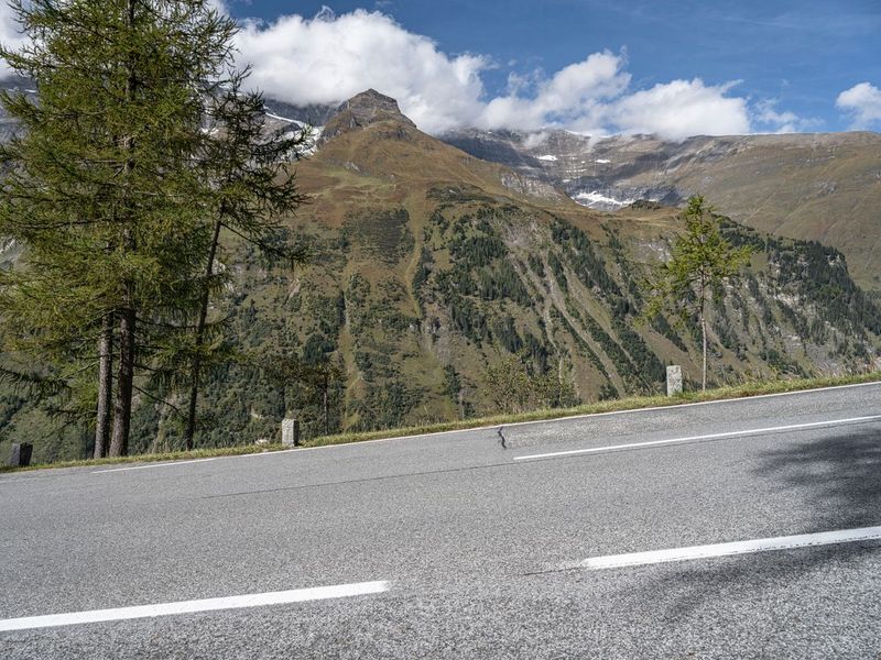 Motorcycle Rider Parked on Road in Front of Austrian Mountain Landscape ...