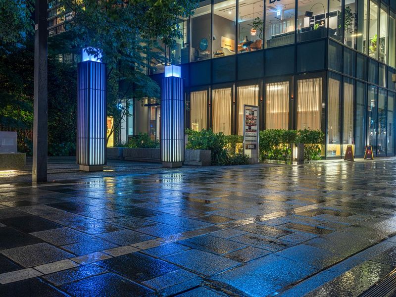 Nighttime Cityscape in Tokyo with Illuminated Roads and Storefronts ...