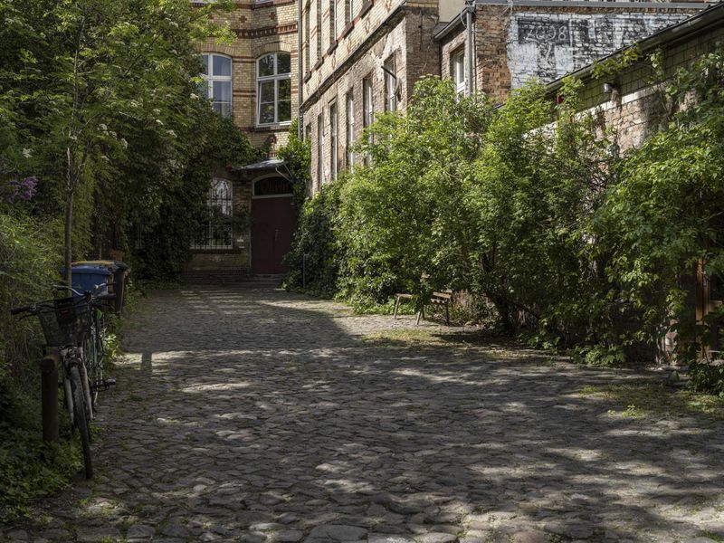 Old Building Courtyard with Cobblestones and Trees in Berlin, Germany ...