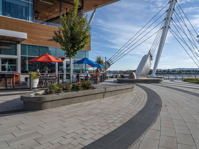 People Eating on Patio Furniture near Water in Front of Building HDRi ...