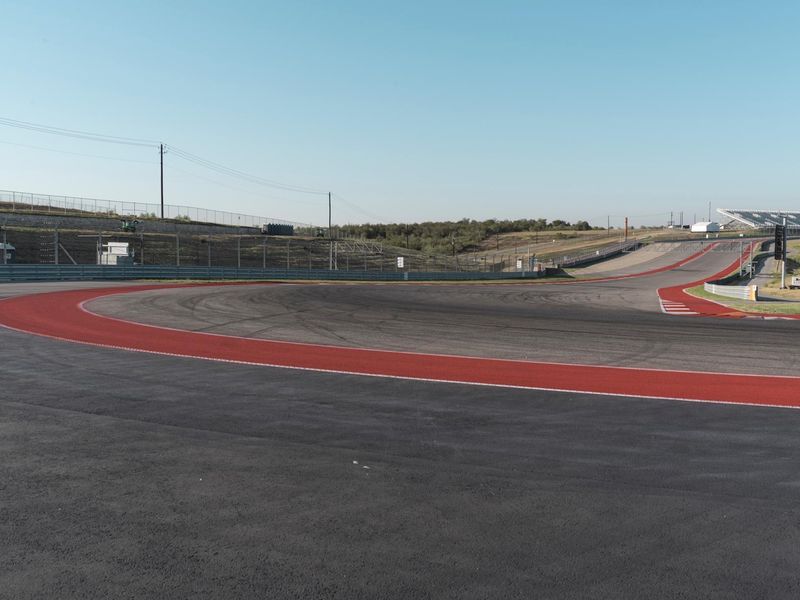Red Curved Race Track under Clear Sky HDRi Maps and Backplates