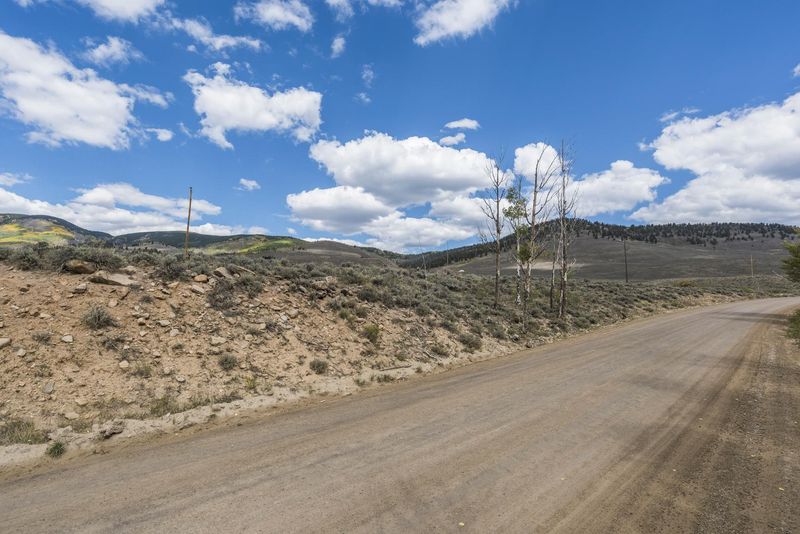 Rural Road Through Low Hills and Fields HDRi Maps and Backplates