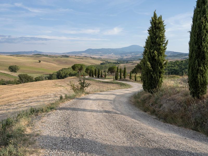Scenic Gravel Road in Italian Countryside with Rolling Hills and Clear ...