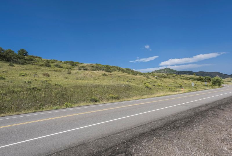 Scenic Roadside View with Bicycle on Grassy Hill under Clear Blue Sky ...