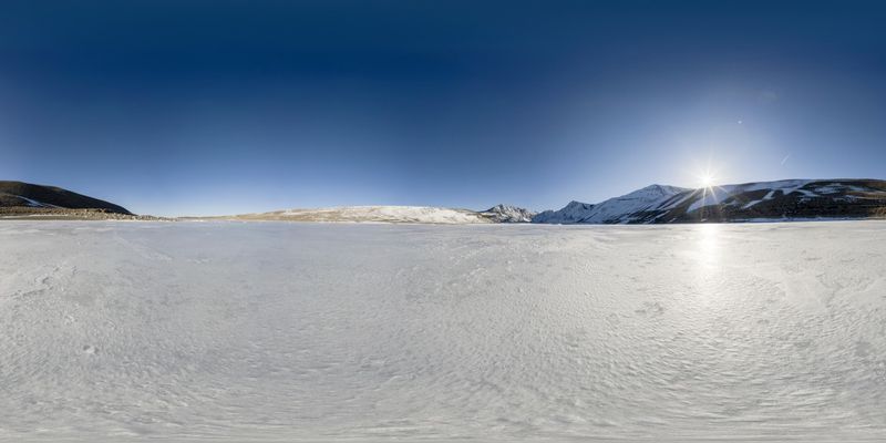 Snowboarder Performing a Trick on a Wide Open Plain with Mountains HDRi ...