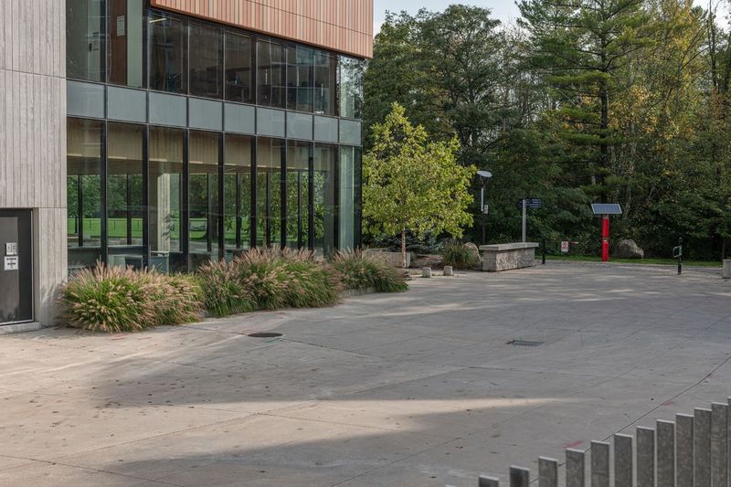 Urban Design in Toronto: Open Air Parking Lot near Tall Building with ...